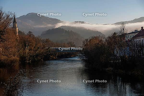 View of the river mur river, in the back the church tower of the ...