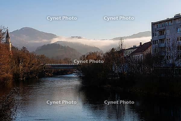 View of the river mur river, in the back the church tower of the ...