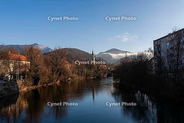 View of the river mur river, in the back the church tower of the ...